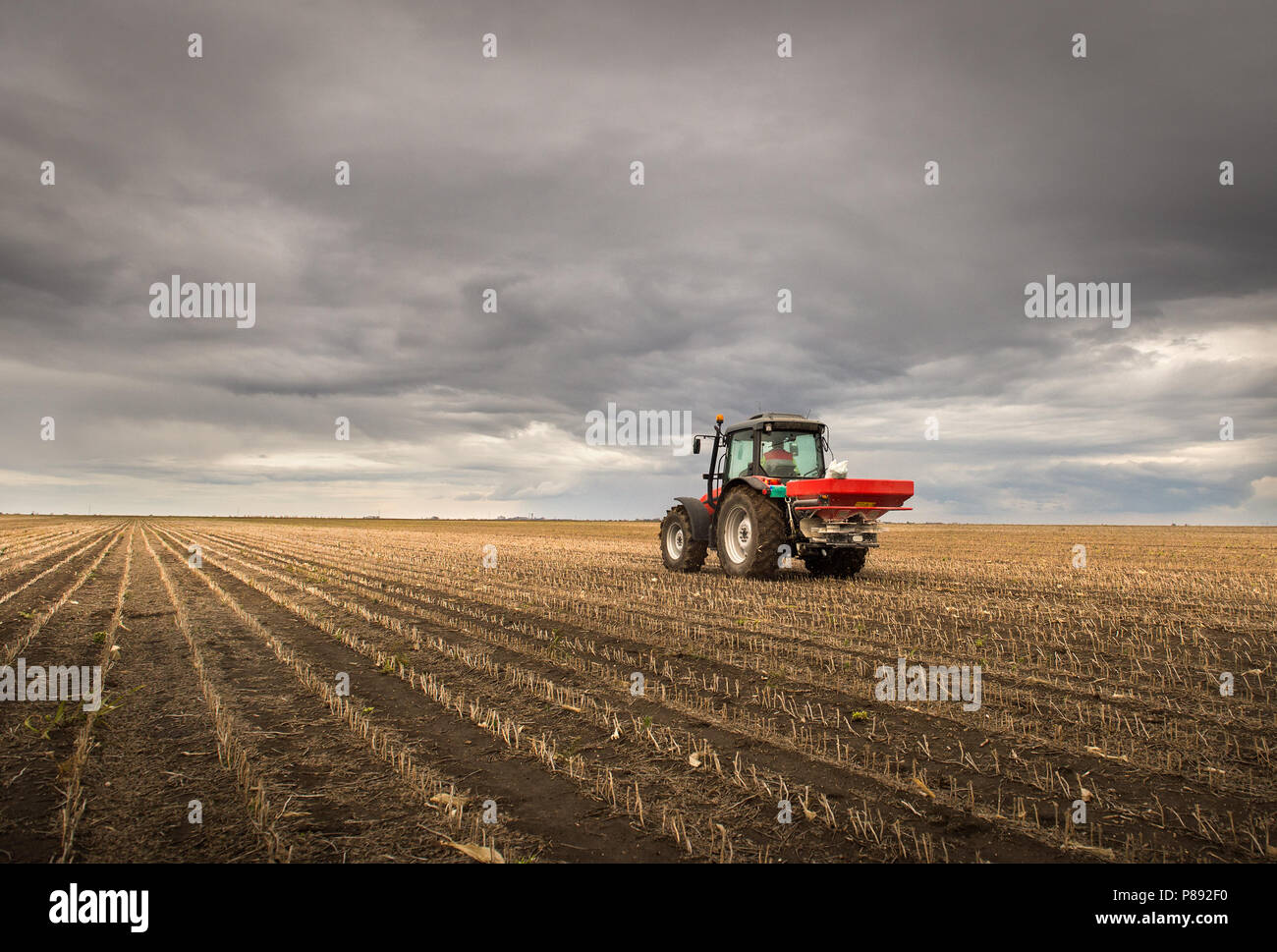 Tractor spreading artificial fertilizers in field Stock Photo - Alamy