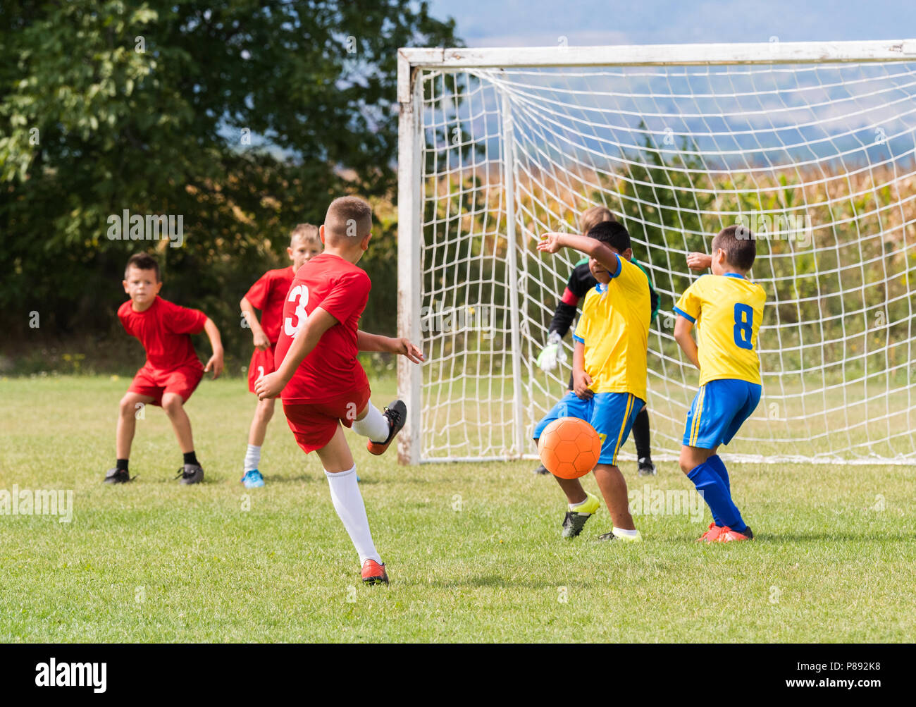Kids soccer football - young children players match on soccer field ...
