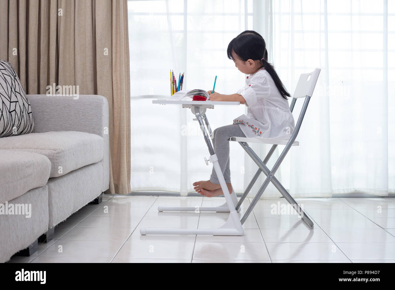 Asian Little Chinese girl doing homework at home Stock Photo - Alamy