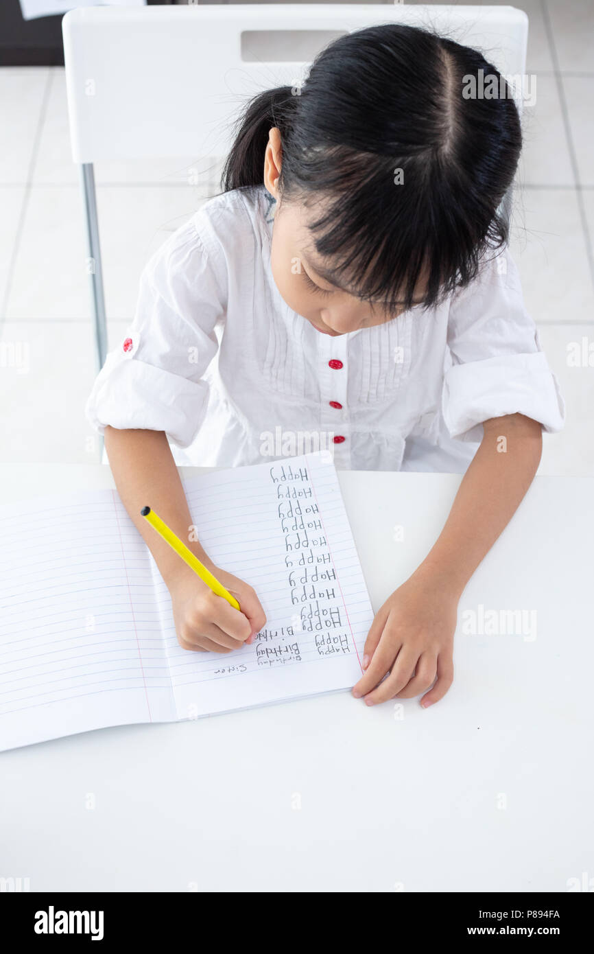 Asian Little Chinese girl doing homework at home Stock Photo - Alamy