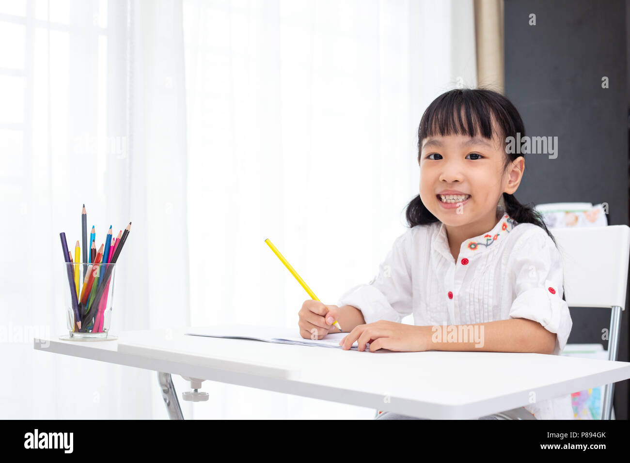 Asian Little Chinese girl doing homework at home Stock Photo - Alamy