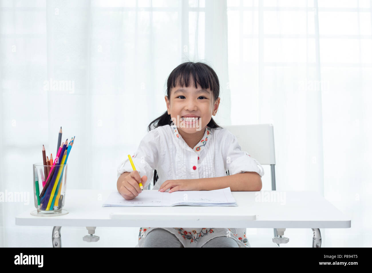 Chinese girl doing homework table hi-res stock photography and images ...