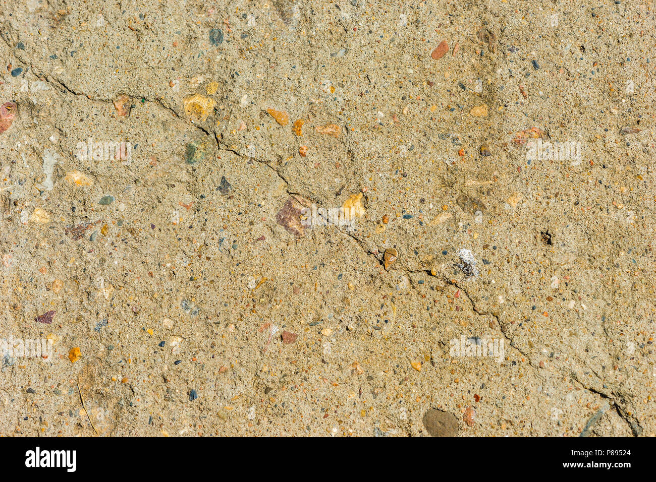 Closeup view of a concrete texture pattern with colorful pebbles or ...