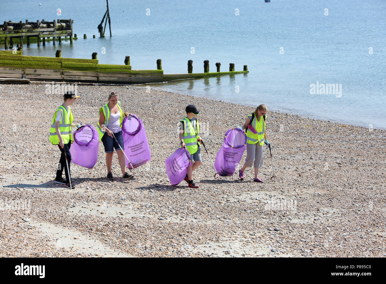 Teenagers clean beach waste hi-res stock photography and images - Alamy