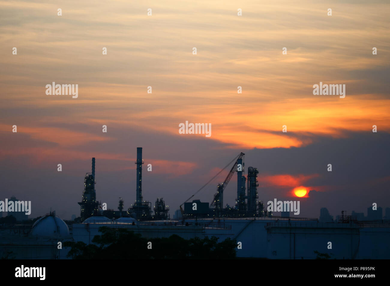 Oil refinery at sunset Stock Photo - Alamy