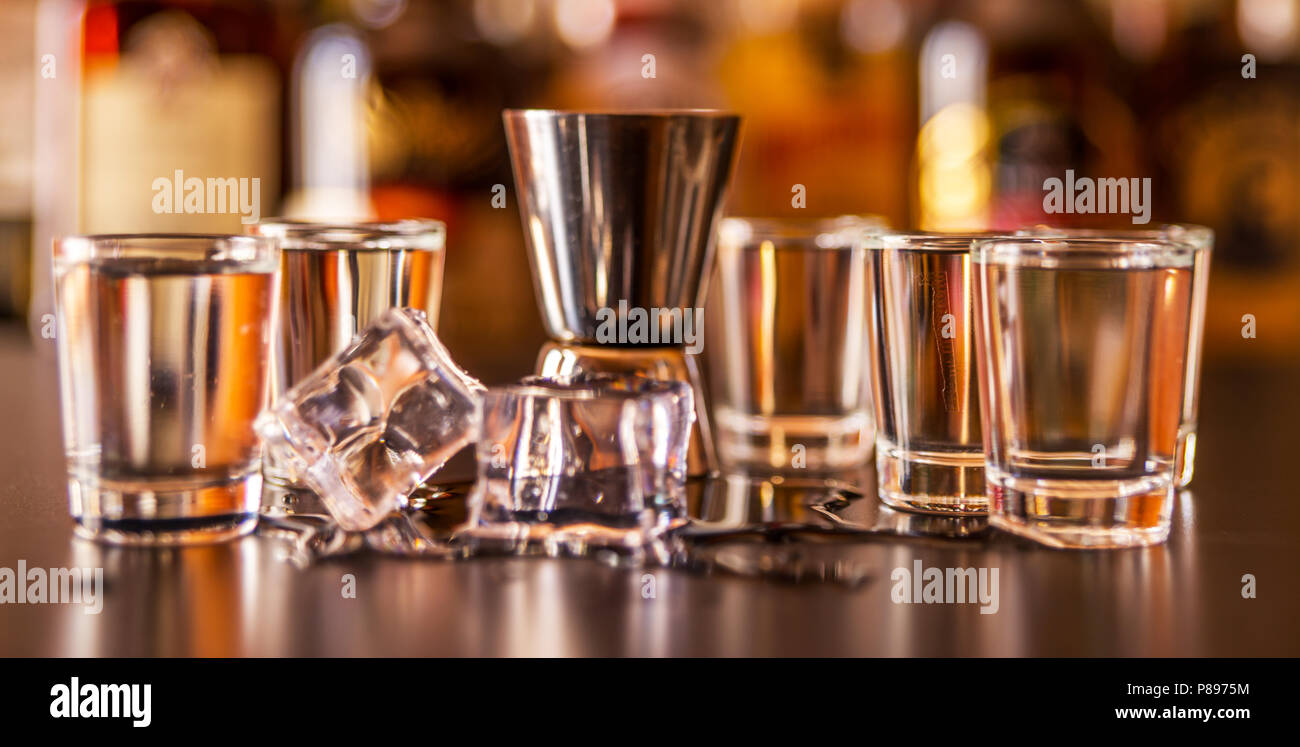 Traditional pure vodka in glasses on a black background, chilled drink ...