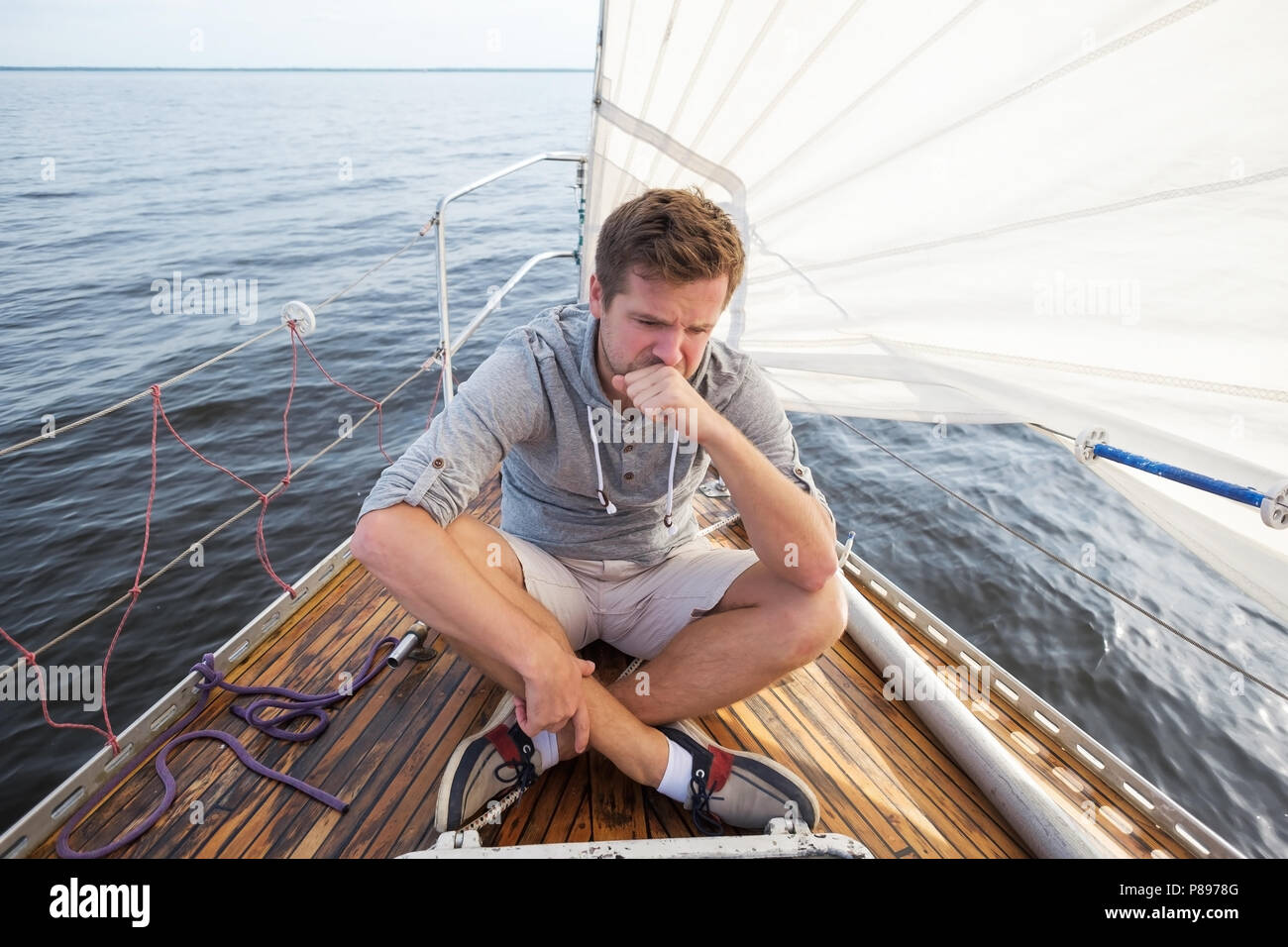 young european man having a nausea seasickness. He is trying to stop ...
