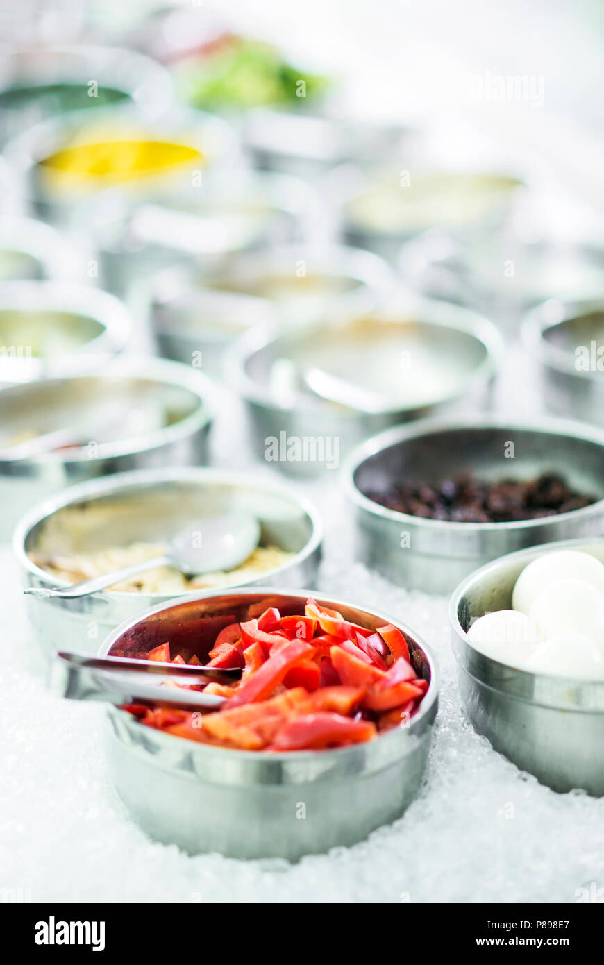 bowls of mixed fresh organic red peppers and vegetables in modern salad ...