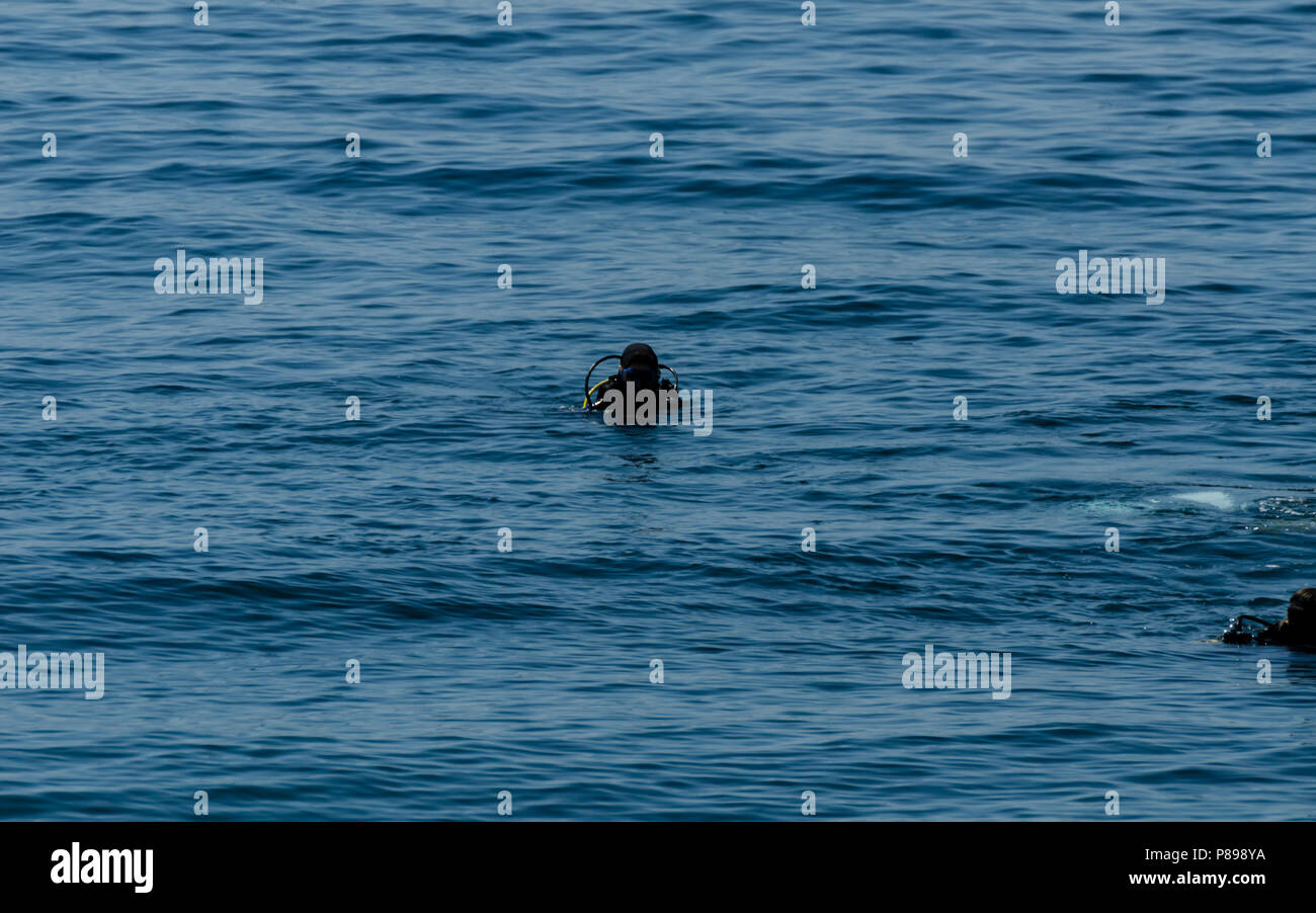 LA HERRADURA, SPAIN - JUNE 14, 2018 People on the water preparing for immersion and discovering ...