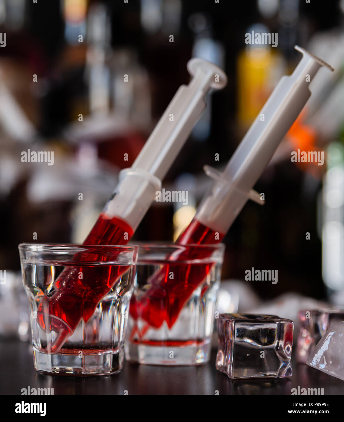 creepy halloween party cocktails with syringes of grenadine syrup as ...