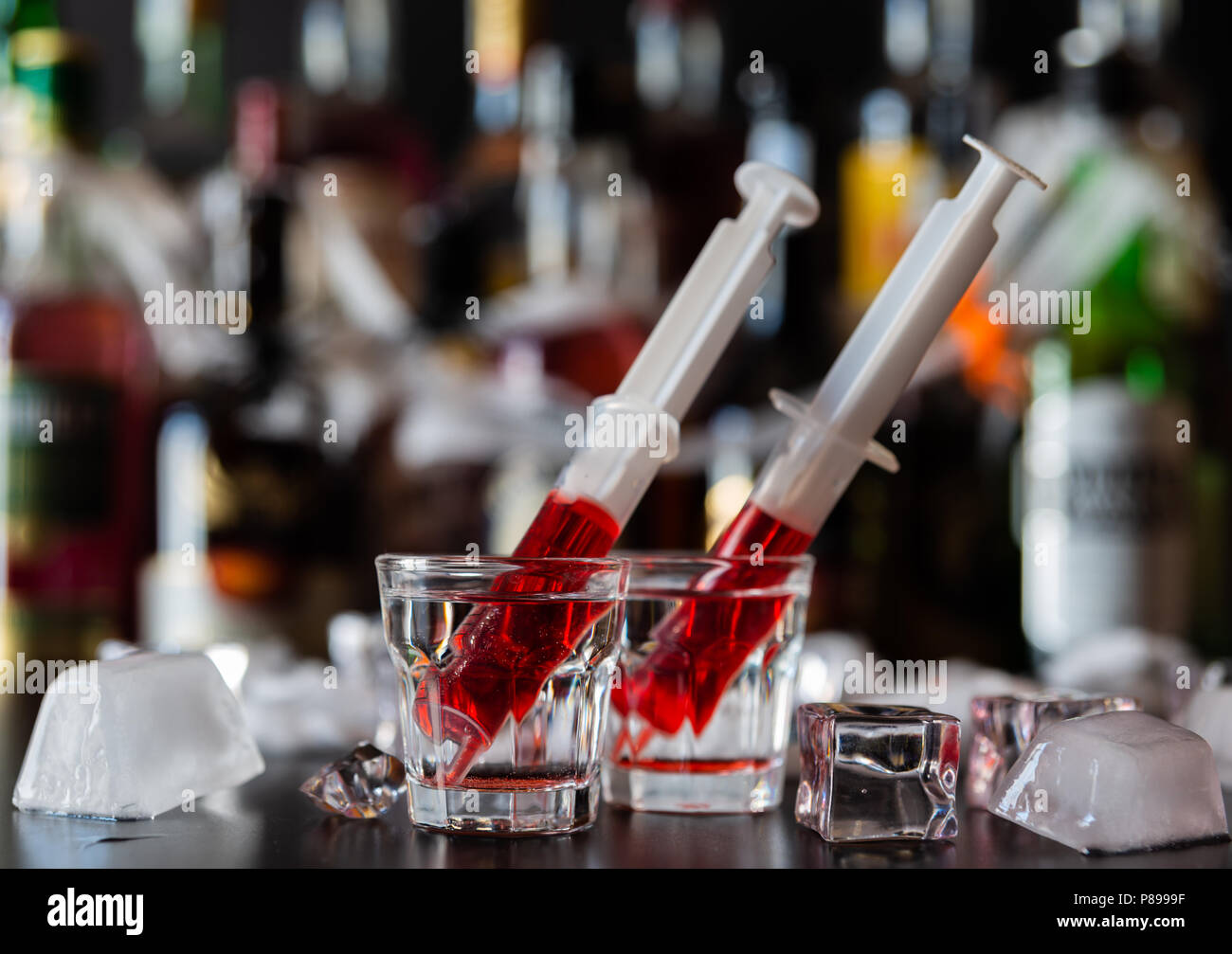 creepy halloween party cocktails with syringes of grenadine syrup as ...