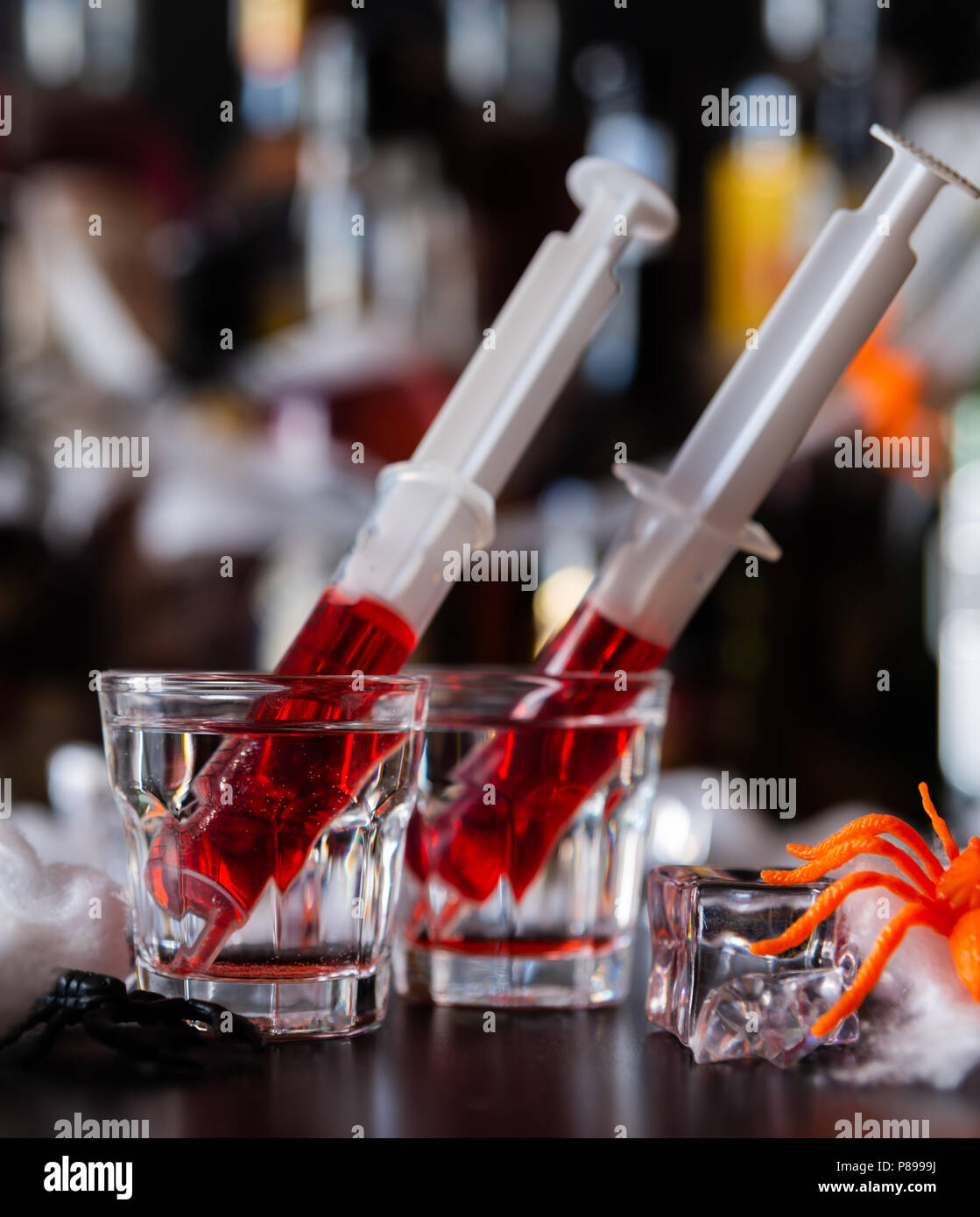 creepy halloween party cocktails with syringes of grenadine syrup as ...