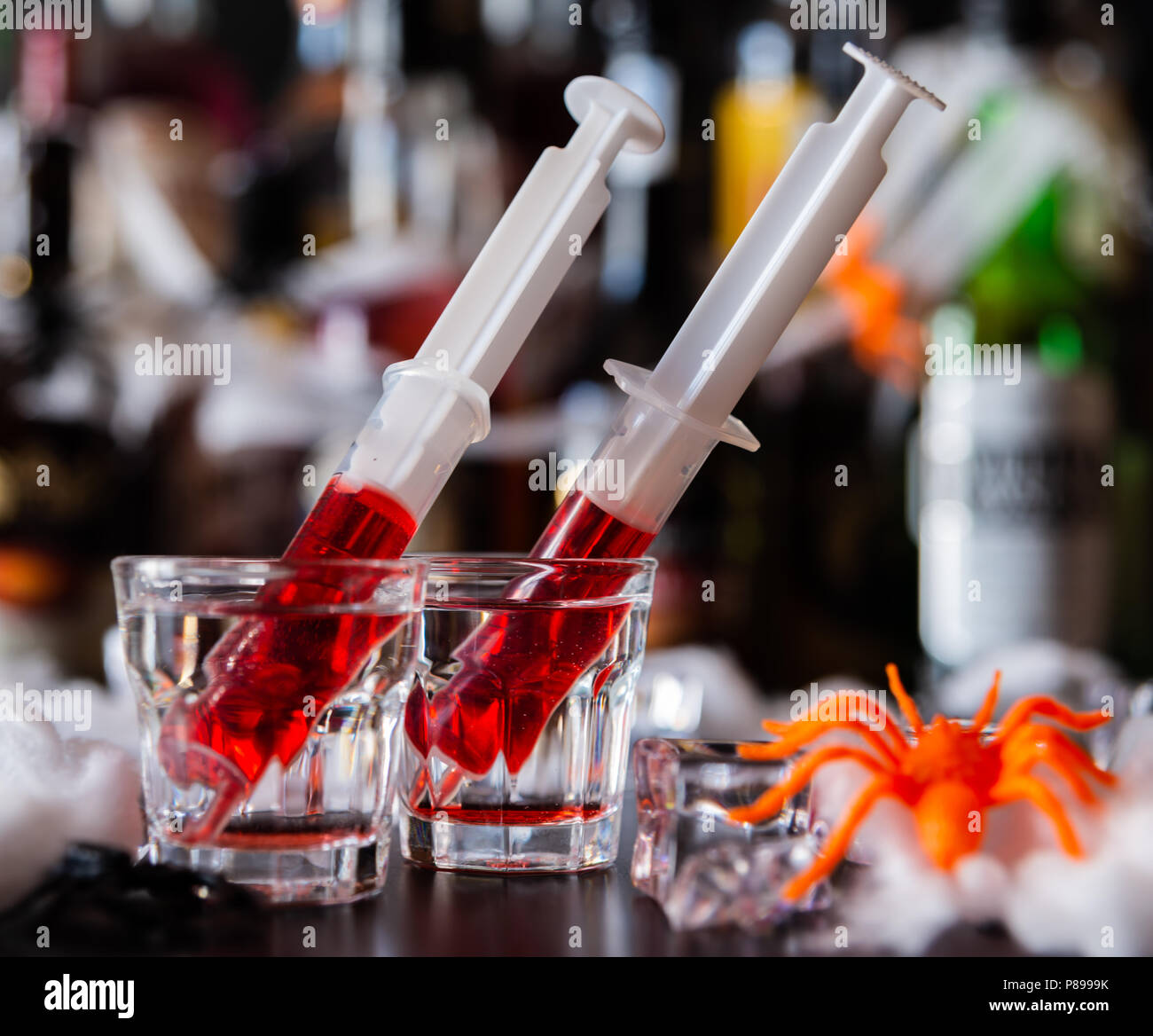 creepy halloween party cocktails with syringes of grenadine syrup as ...