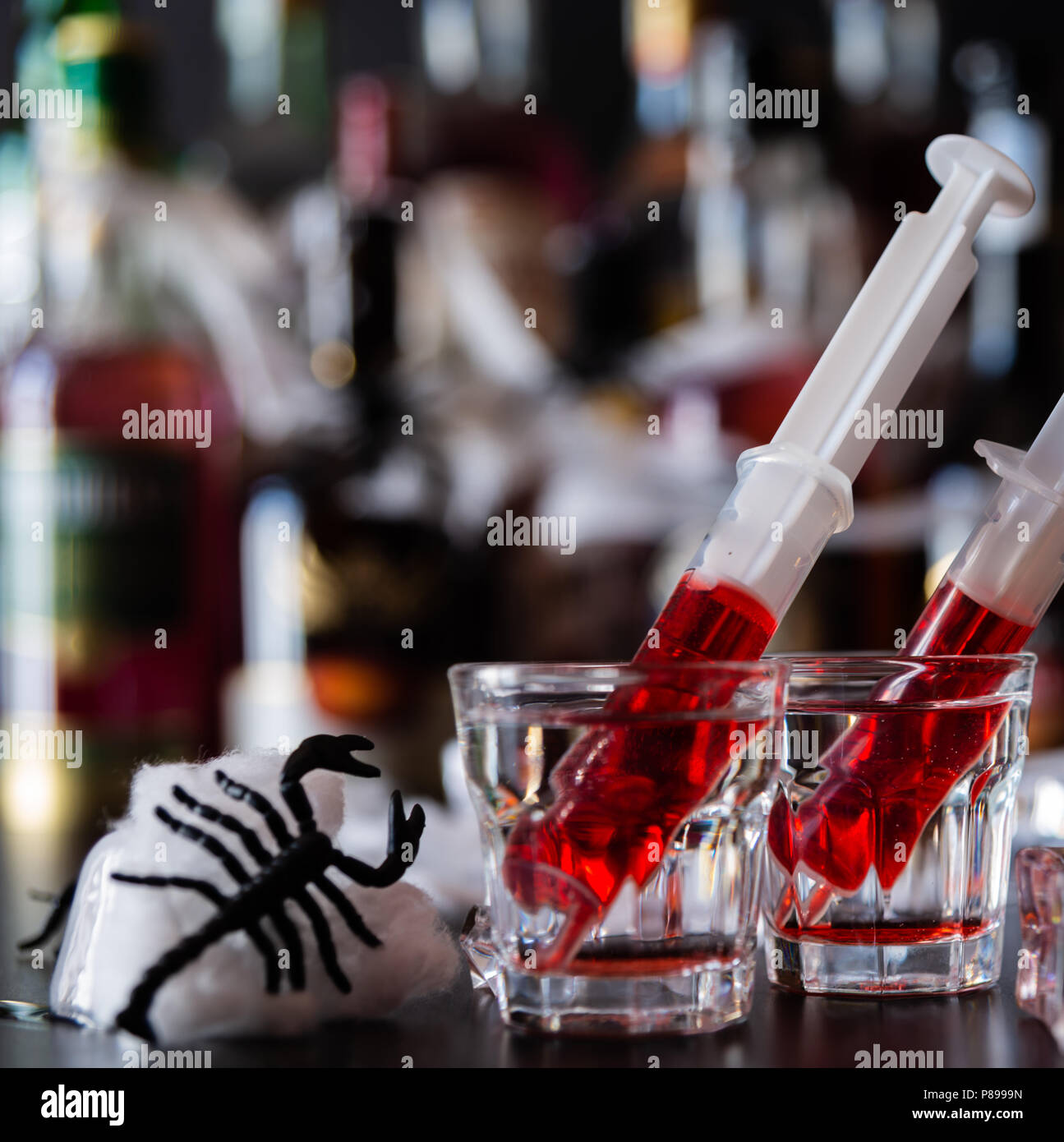 creepy halloween party cocktails with syringes of grenadine syrup as ...