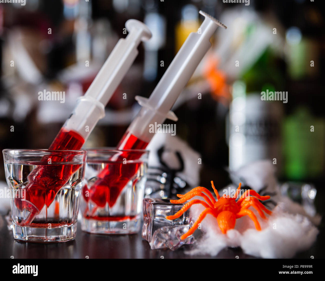 creepy halloween party cocktails with syringes of grenadine syrup as ...