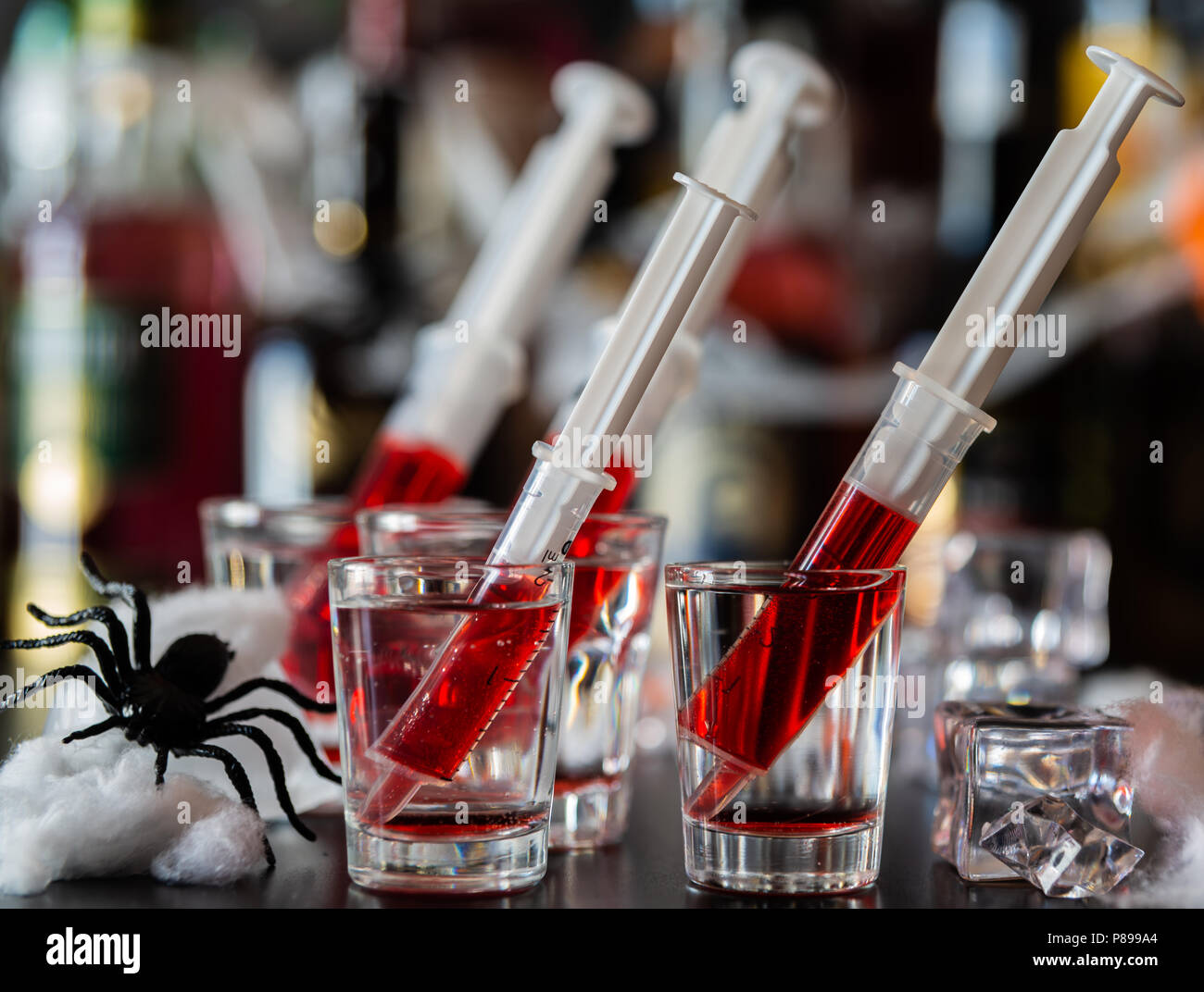 creepy halloween party cocktails with syringes of grenadine syrup as ...