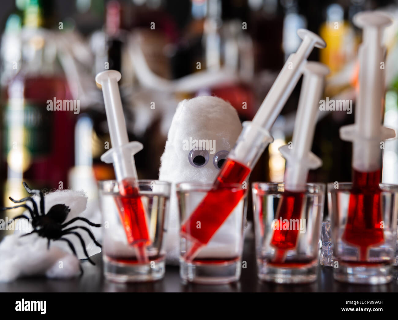 creepy halloween party cocktails with syringes of grenadine syrup as ...