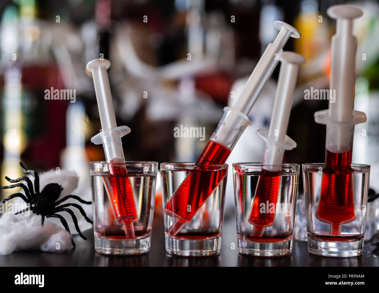 creepy halloween party cocktails with syringes of grenadine syrup as ...