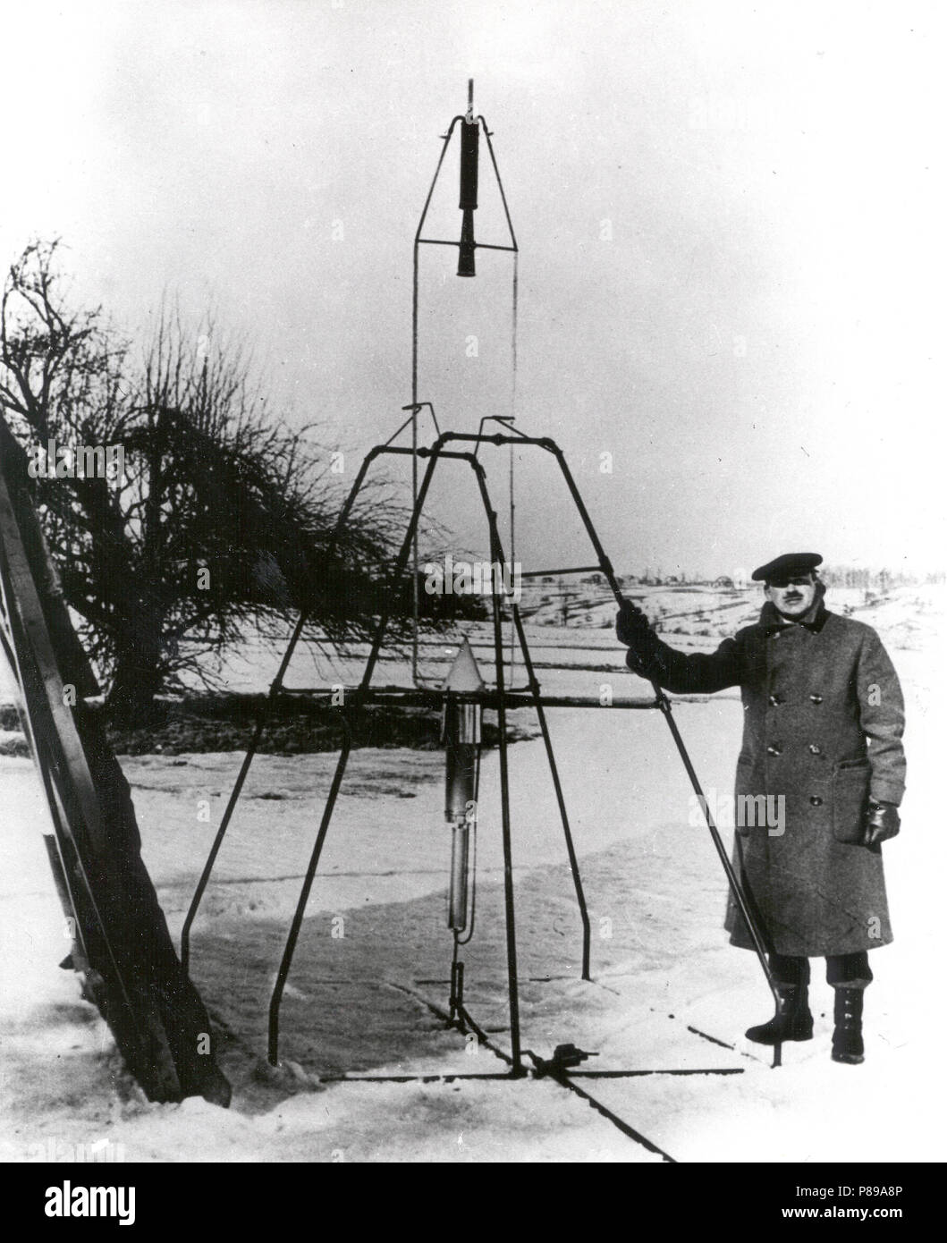 Dr. Robert H. Goddard and a liquid oxygen-gasoline rocket in the frame ...
