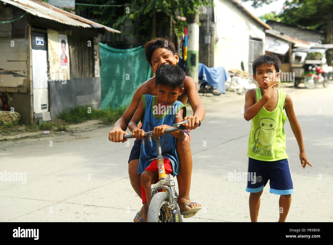 ANGONO, RIZAL, PHILIPPINES - JULY 4 2018: Young Filipino children play ...