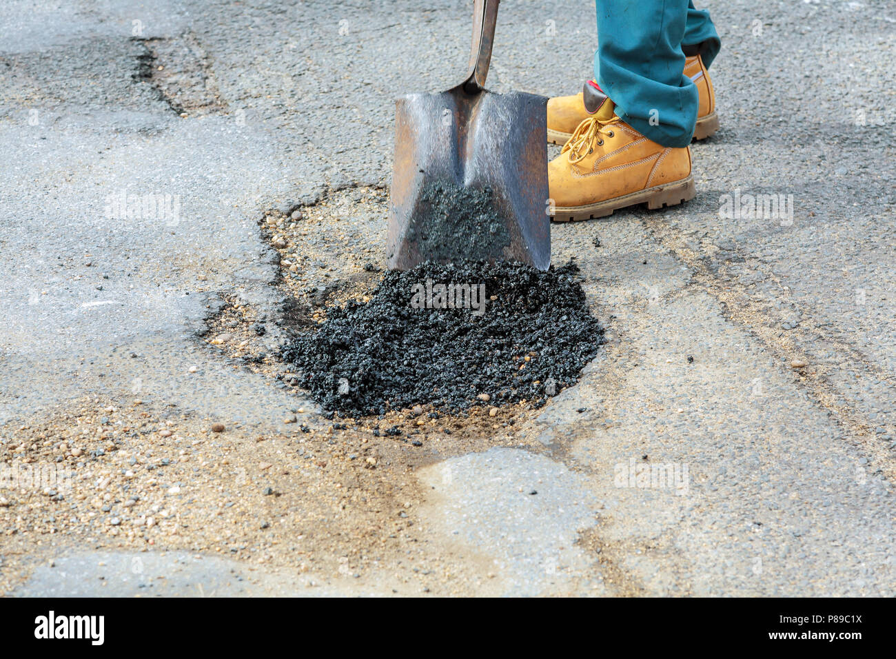 Asphalt Paving Street resurfacing. Fresh asphalt construction. Bad road ...
