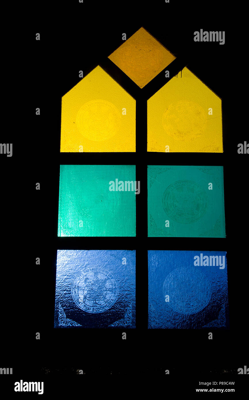 Window fitted with blue, green, yellow and brown glass window panes ...