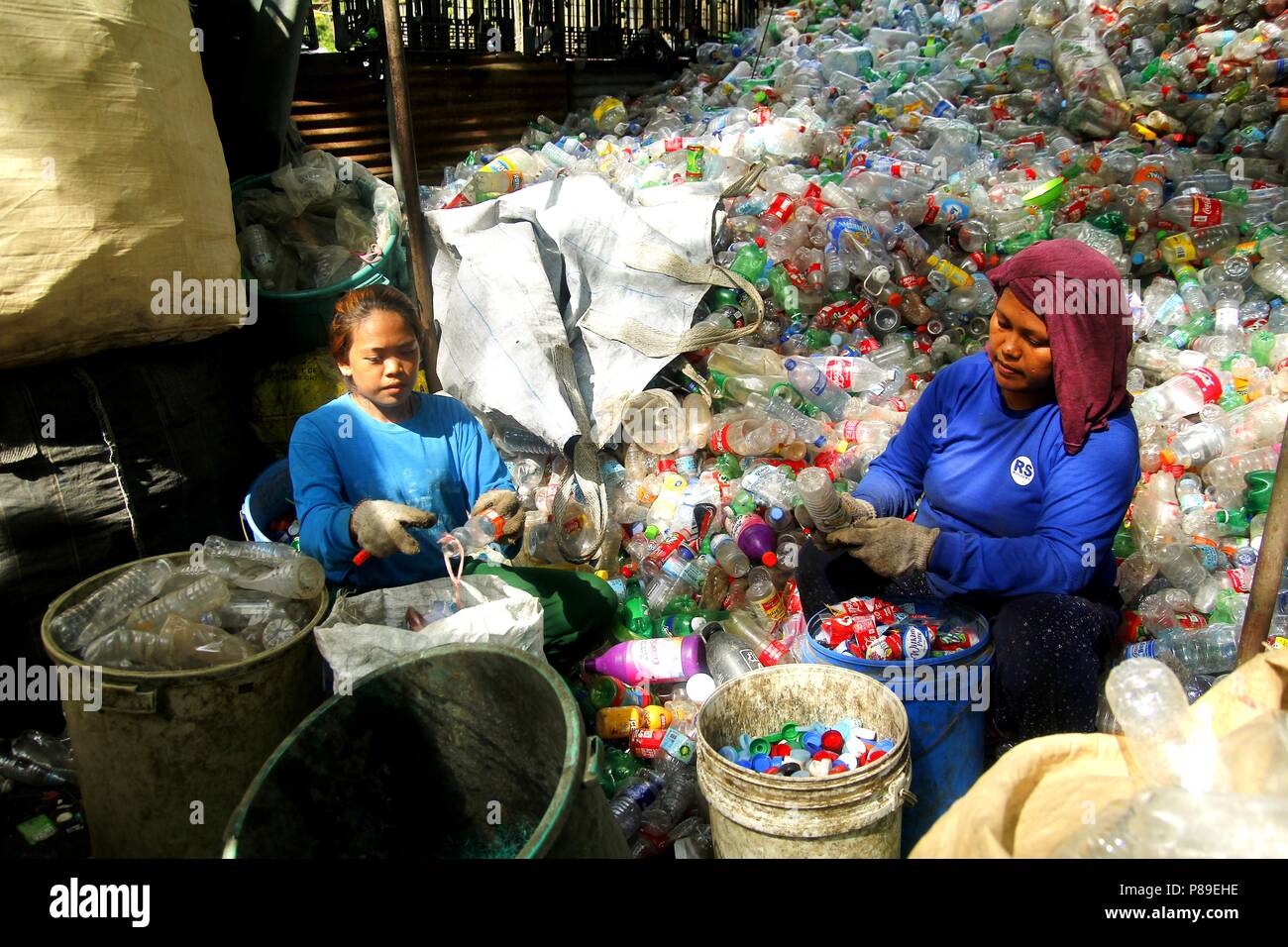 ANGONO, RIZAL, PHILIPPINES - JULY 4 2018: Workers of a materials ...