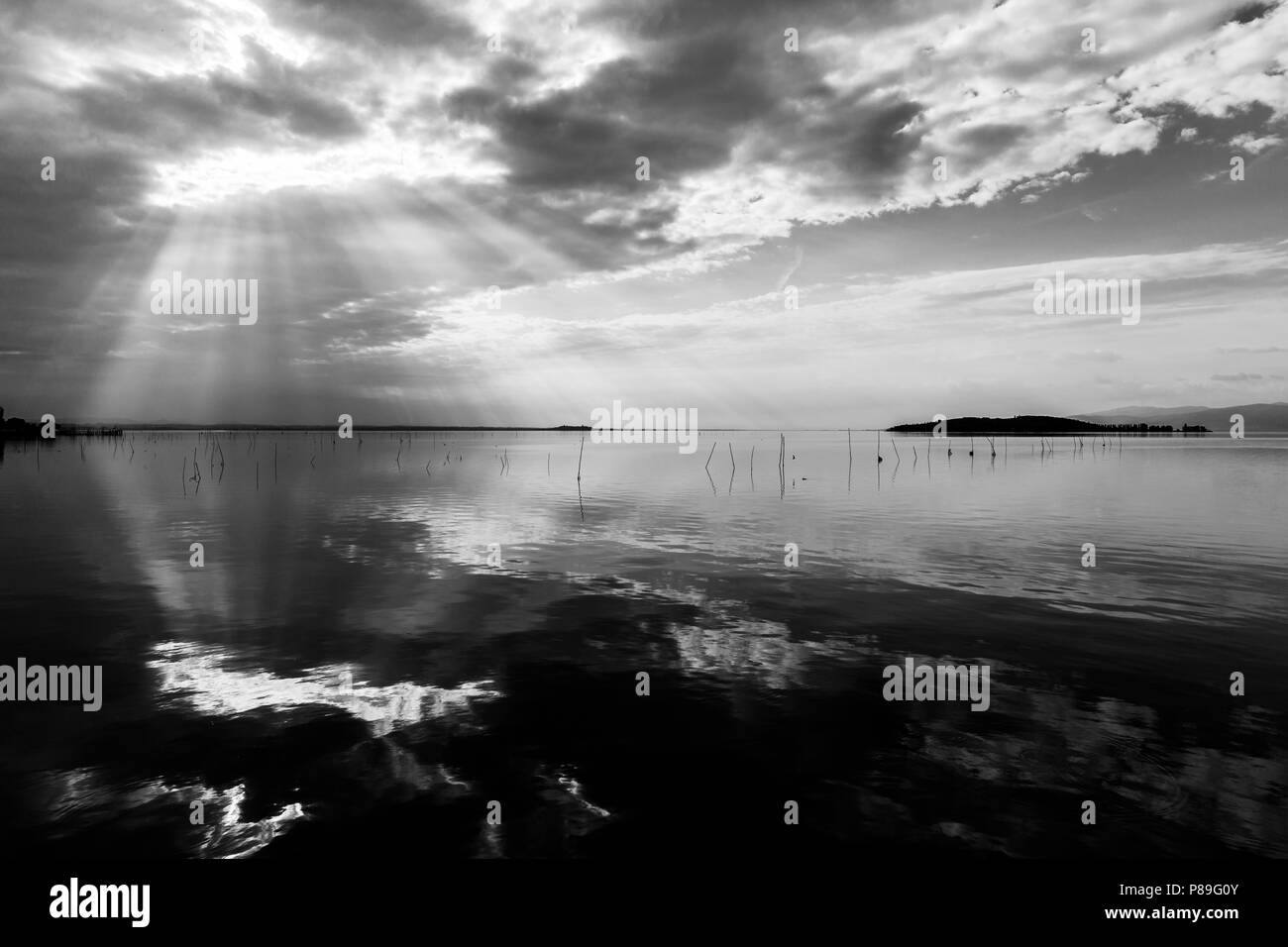 Perfectly symmetric and spectacular view of a lake, with clouds, sky ...