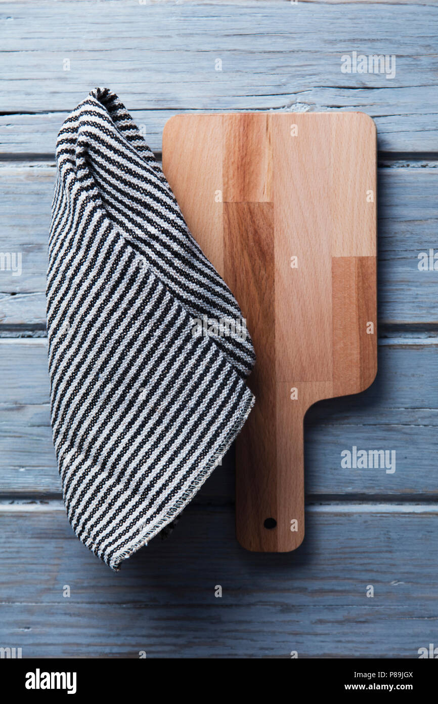 Wooden chopping board and cloth on a rustic wood plank table Stock ...