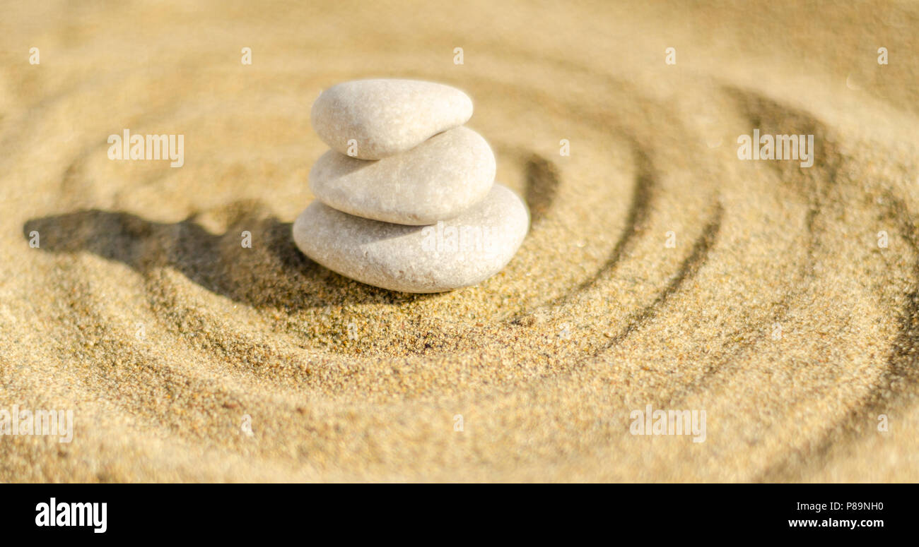 zen meditation stone in sand, concept for purity harmony and ...