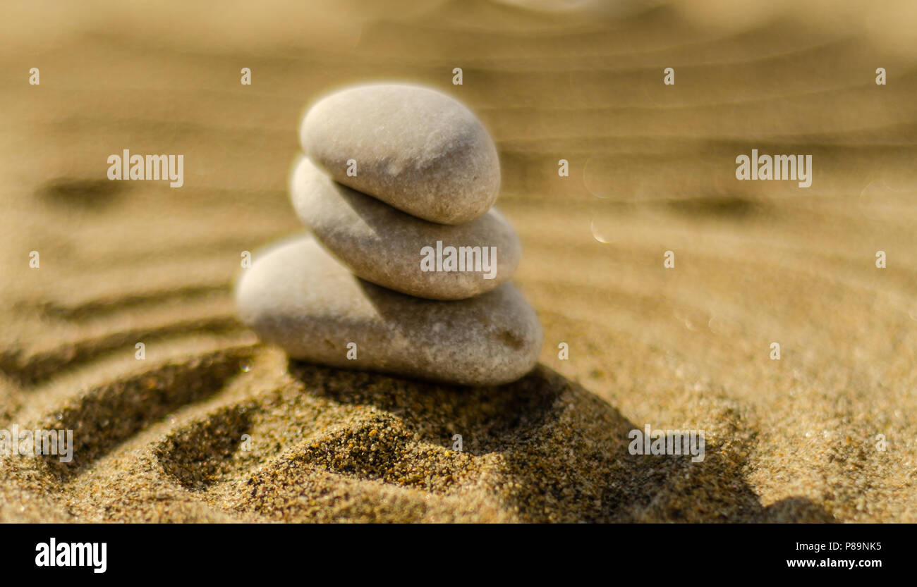 zen meditation stone in sand, concept for purity harmony and ...