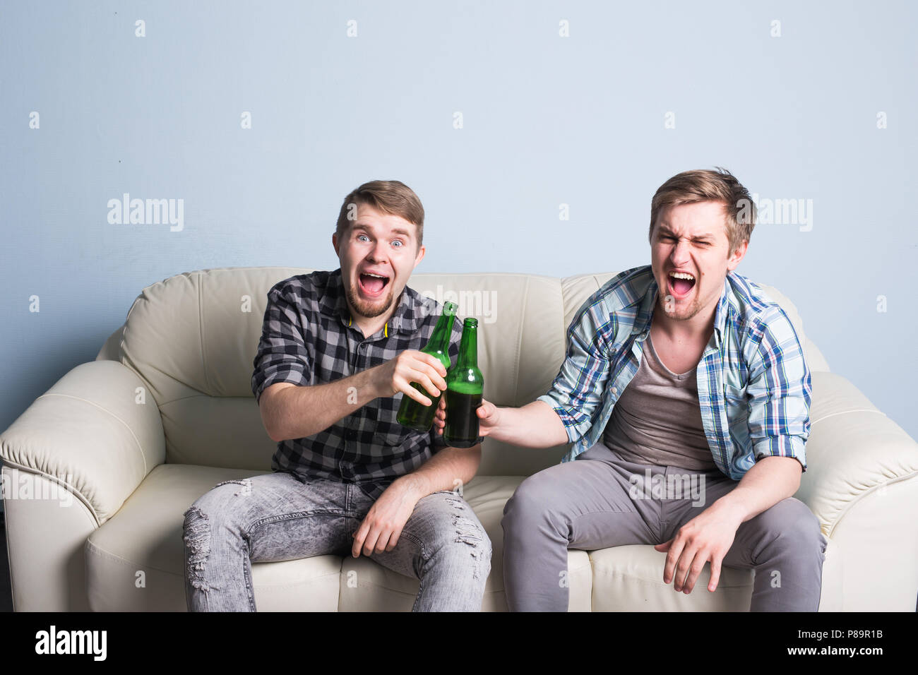 Group of friends watching sport together, Young men drink beer Stock ...
