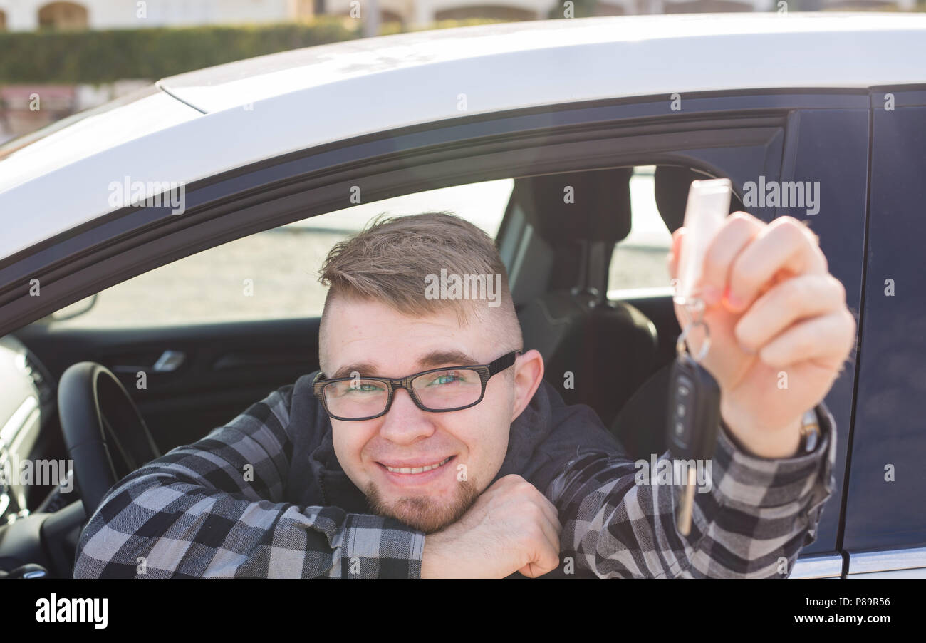Young man sitting in car holding car keys Stock Photo - Alamy