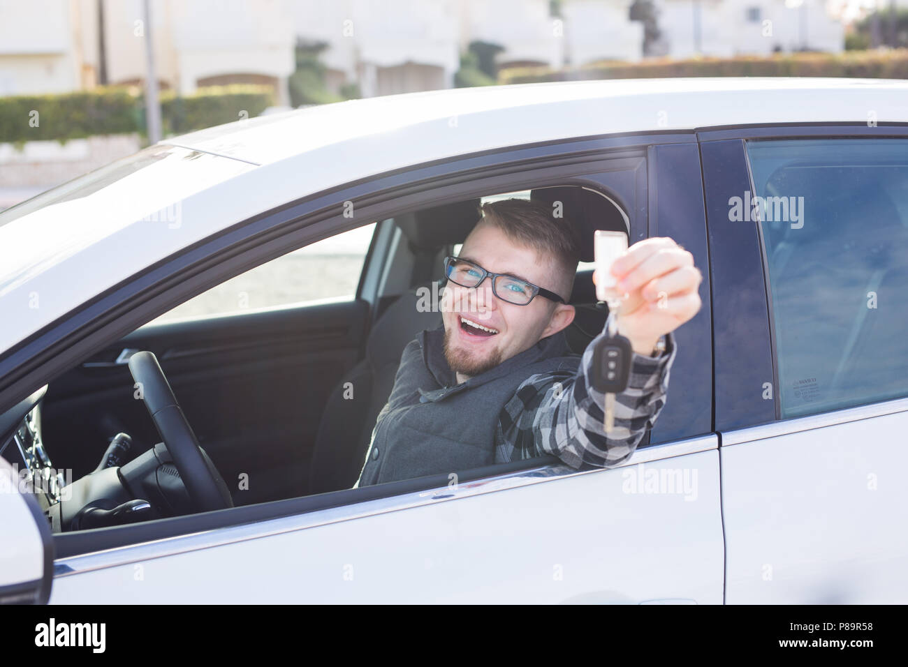 Young man hold key in white car Stock Photo - Alamy
