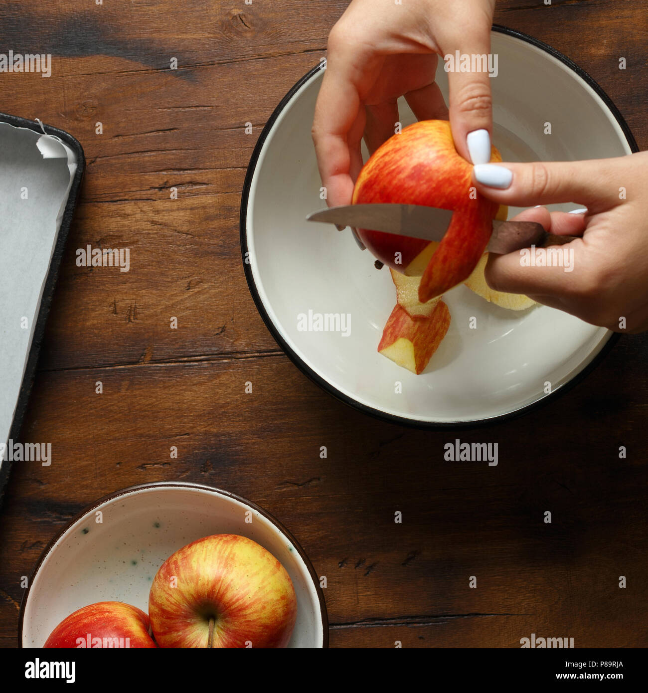 Female hands peel red apples for cooking food from apples, top view ...
