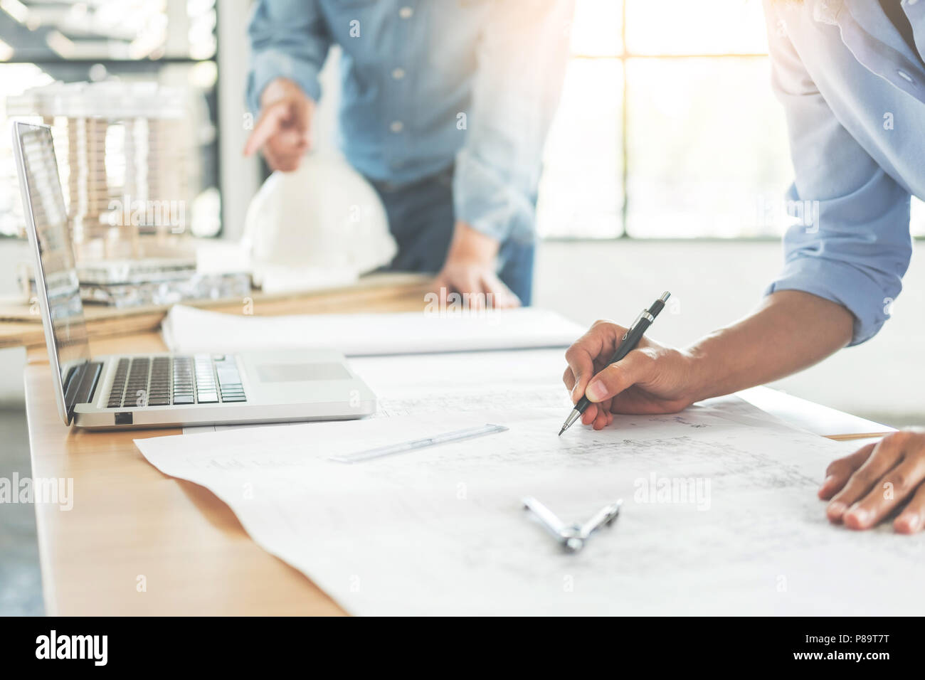Close-up Of Person's engineer Hand Drawing Plan On Blue Print with ...