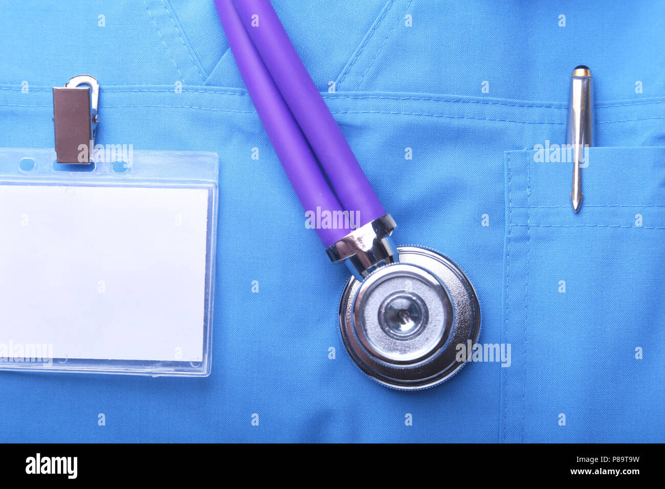 Medical stethoscope lying on a blue doctor's form and notepad close-up ...