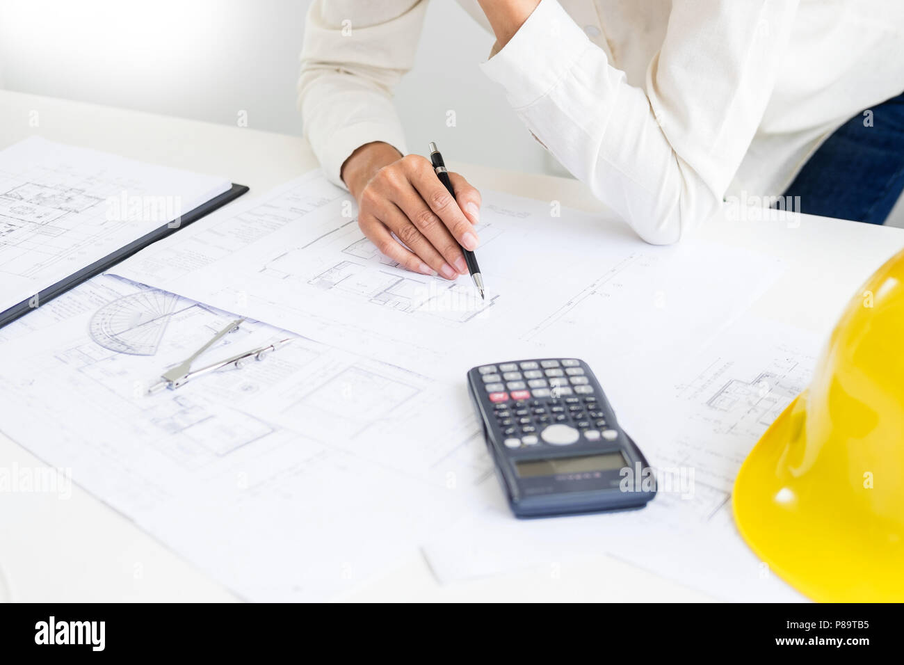 Close-up Of Person's engineer Hand Drawing Plan On Blue Print with ...