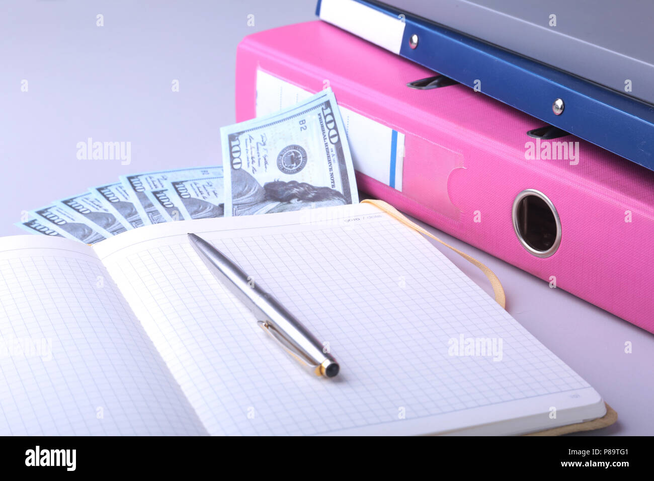 Folder file, note, pen and money on the desk. blurred background Stock ...