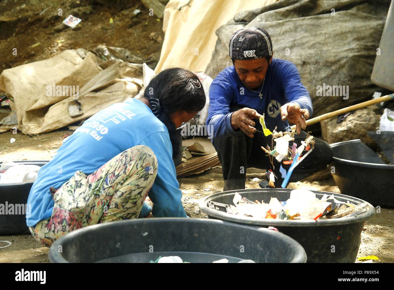 ANGONO, RIZAL, PHILIPPINES - JULY 4 2018: Workers of a materials ...