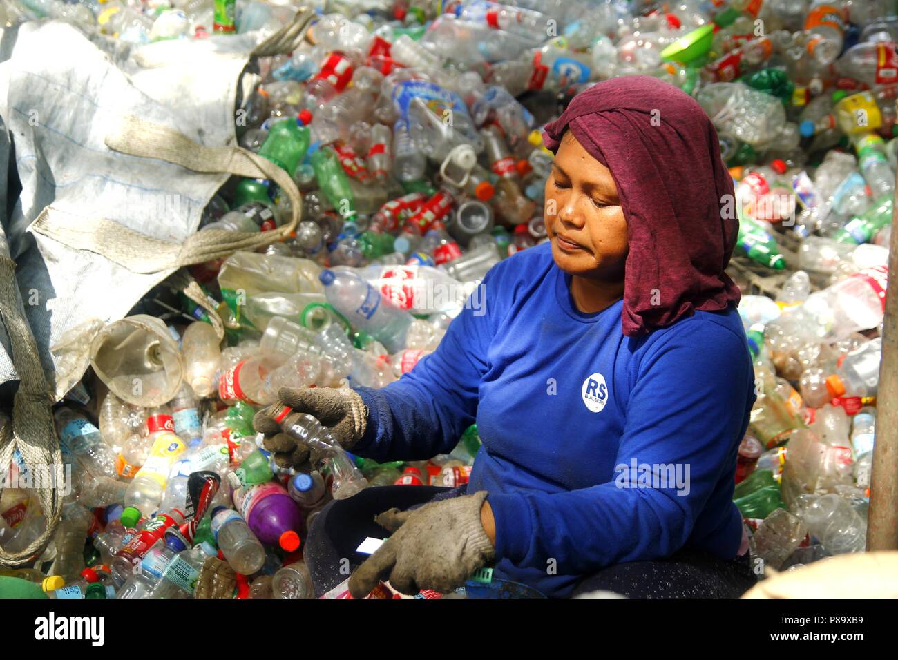 ANGONO, RIZAL, PHILIPPINES - JULY 4 2018: Workers of a materials ...