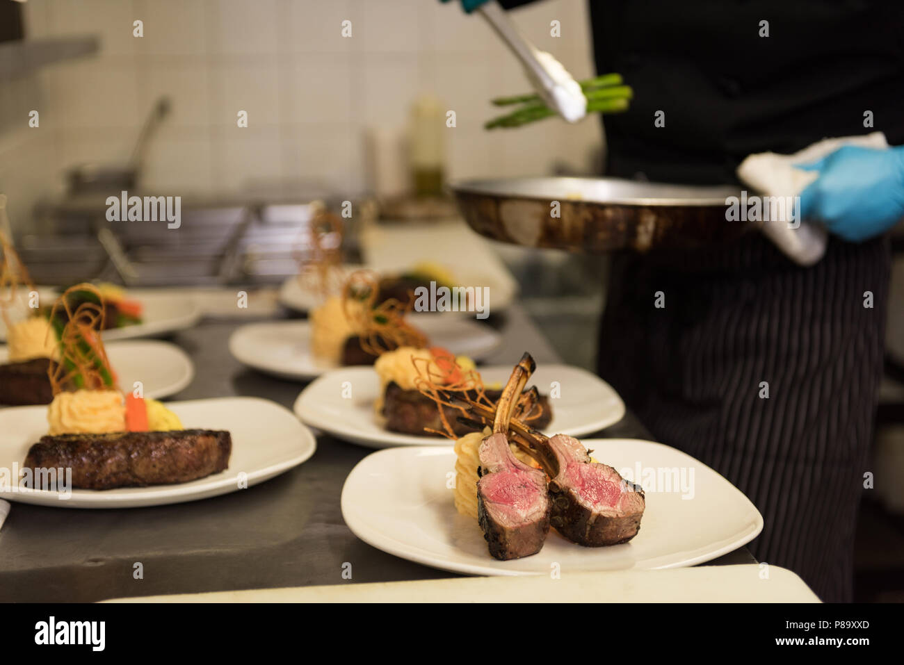 Male chef serving food in a plate Stock Photo - Alamy