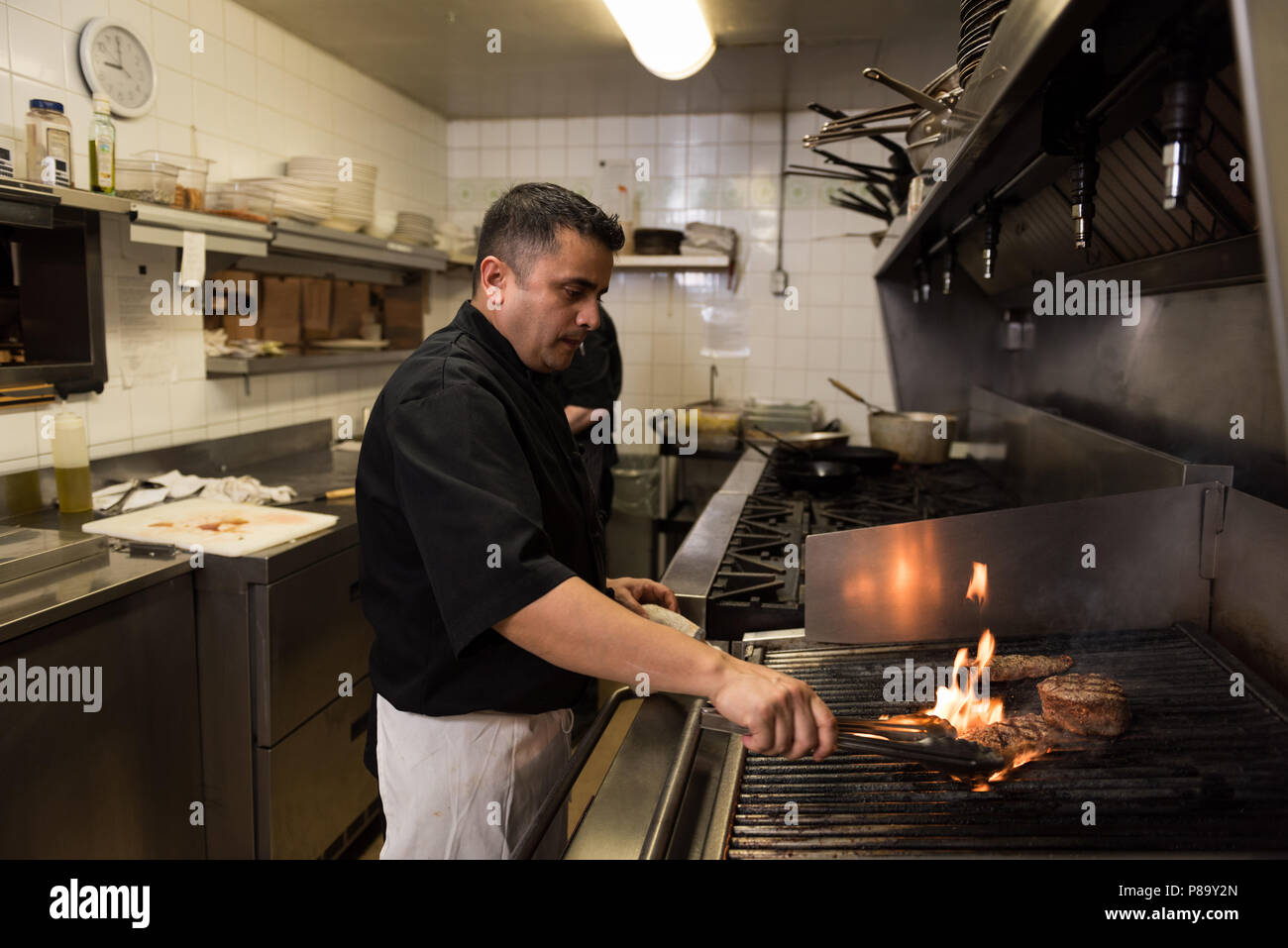 Male chef cooking meat hi-res stock photography and images - Alamy