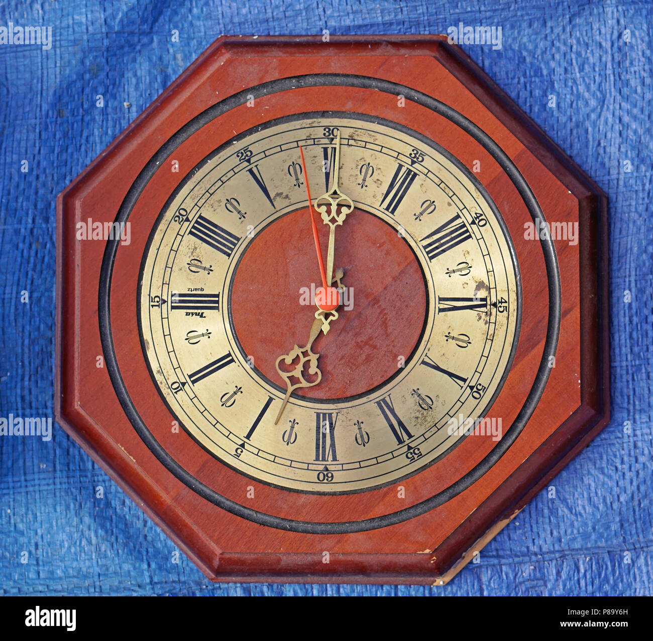 Octagonal wall clock with wood and brass Stock Photo - Alamy