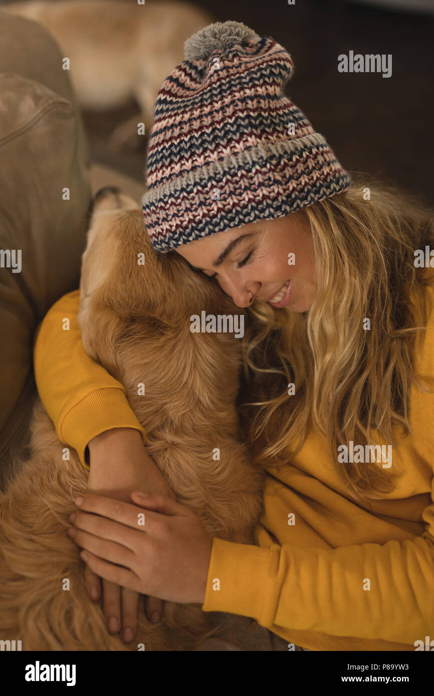 Girl embracing her dog in living room Stock Photo - Alamy