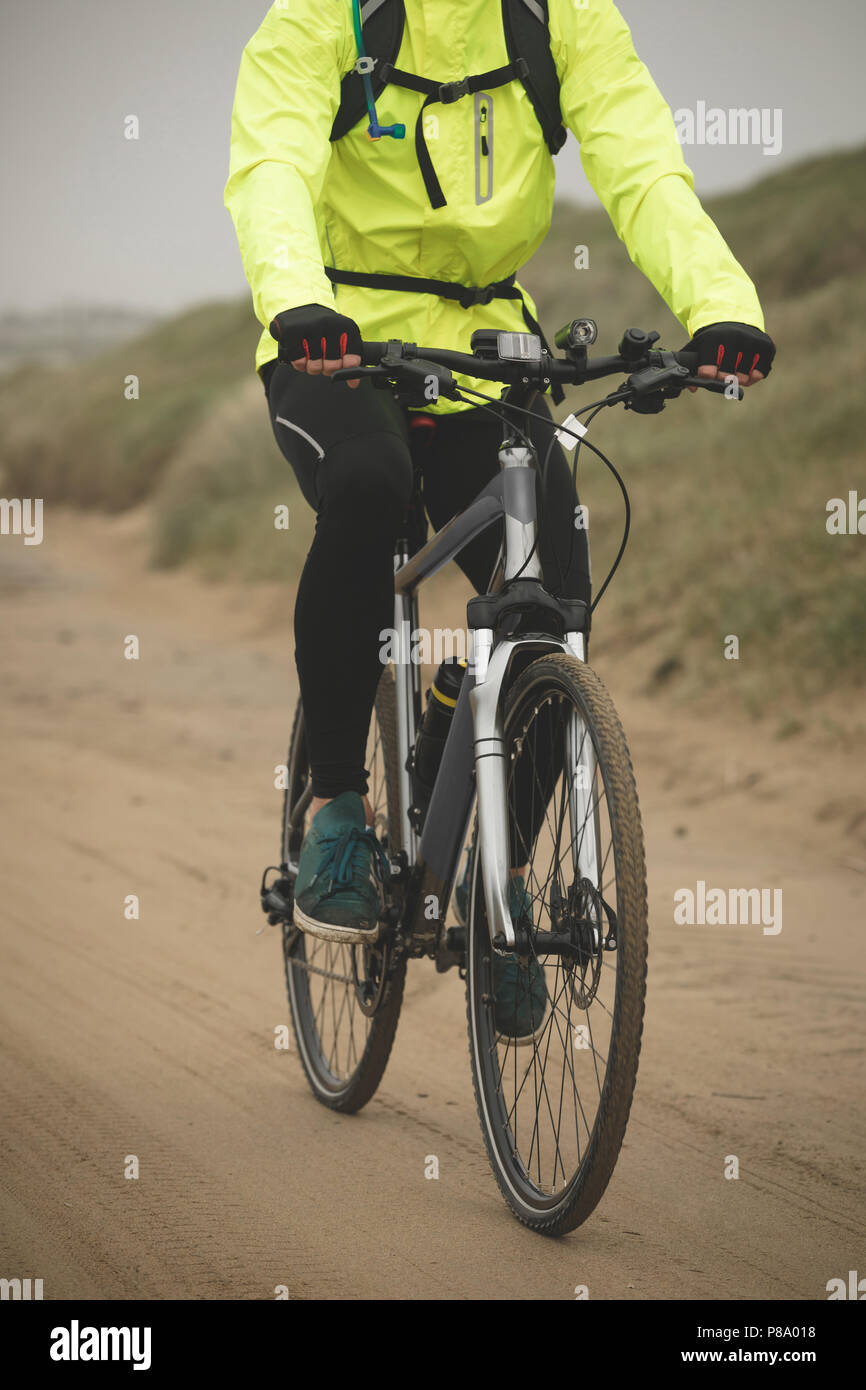 Young man cycling beach hi-res stock photography and images - Alamy