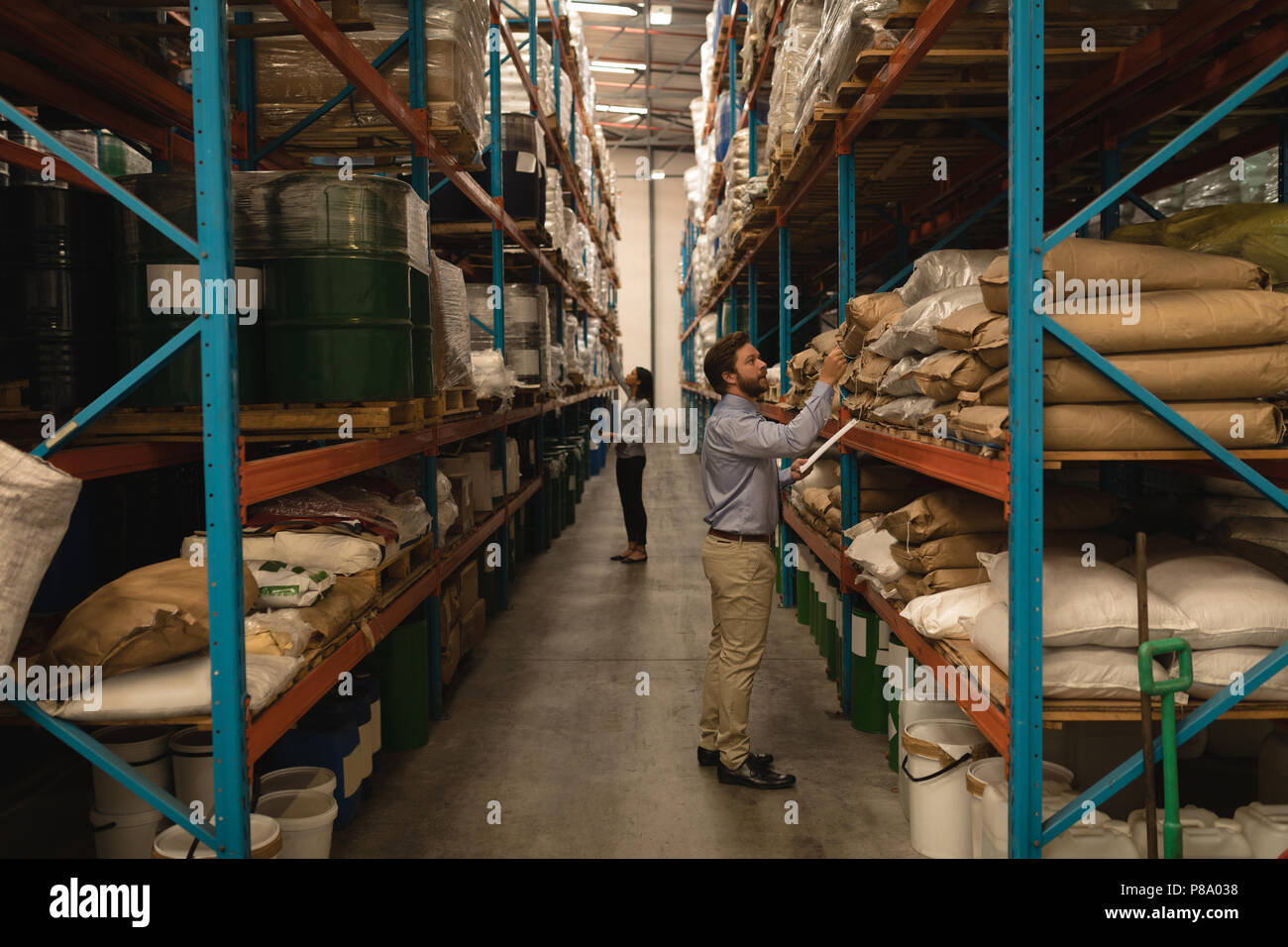 Staff checking stocks in warehouse Stock Photo - Alamy
