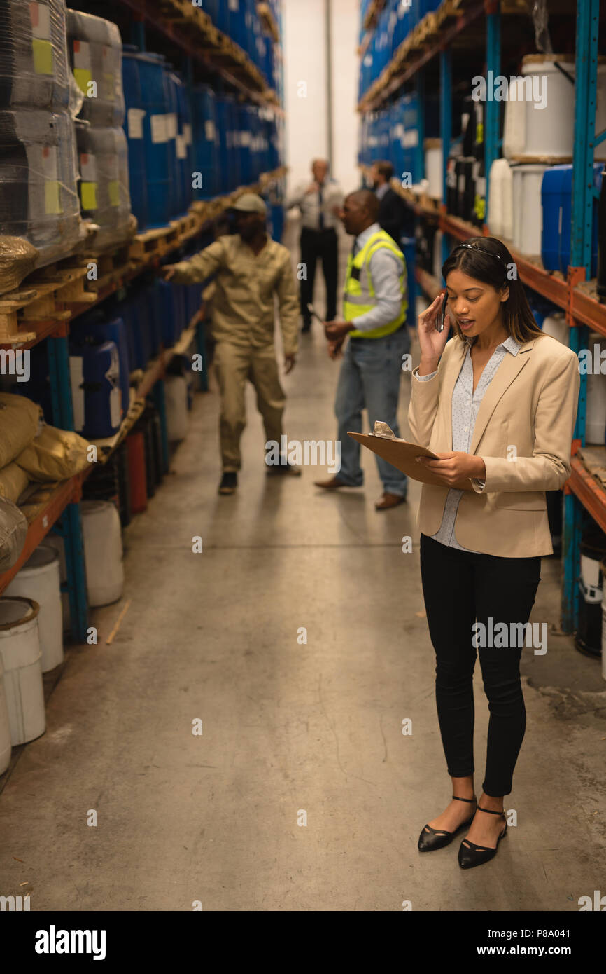 Female supervisor writing on a clipboard Stock Photo - Alamy