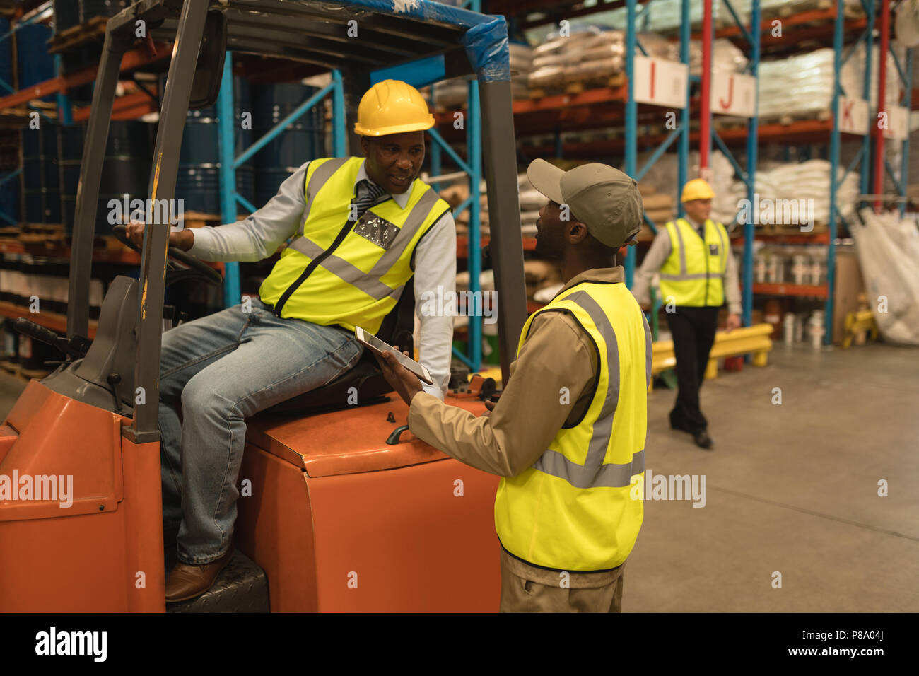 Male workers interacting with each other Stock Photo - Alamy