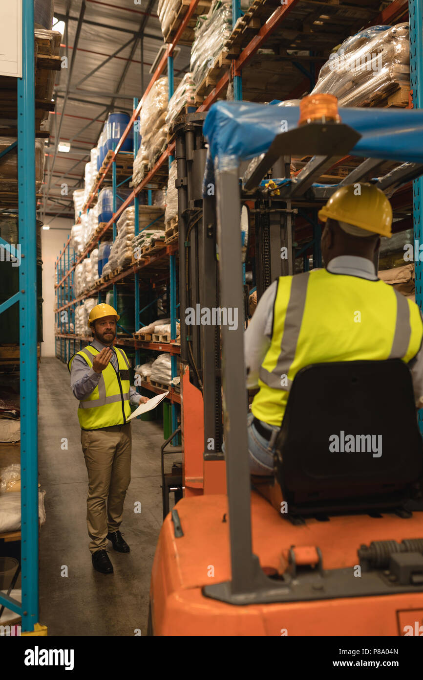 Male workers interacting with each other Stock Photo - Alamy